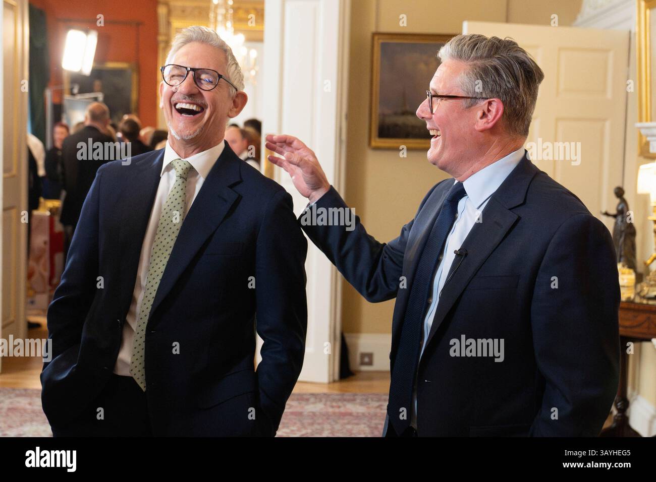 Britain's Prime Minister Keir Starmer, right, laughs with Gary Lineker ...