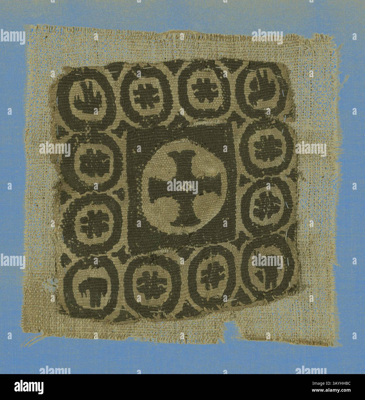 A patterned textile featuring a geometric design with circular motifs ...