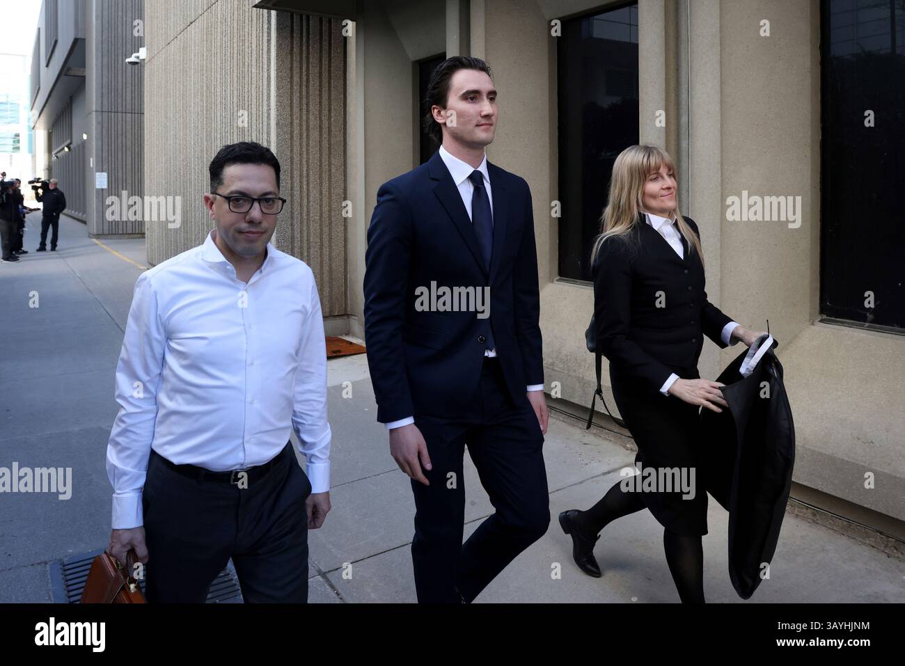 Alex Formenton, center, leaves the London Courthouse in London, Ont ...