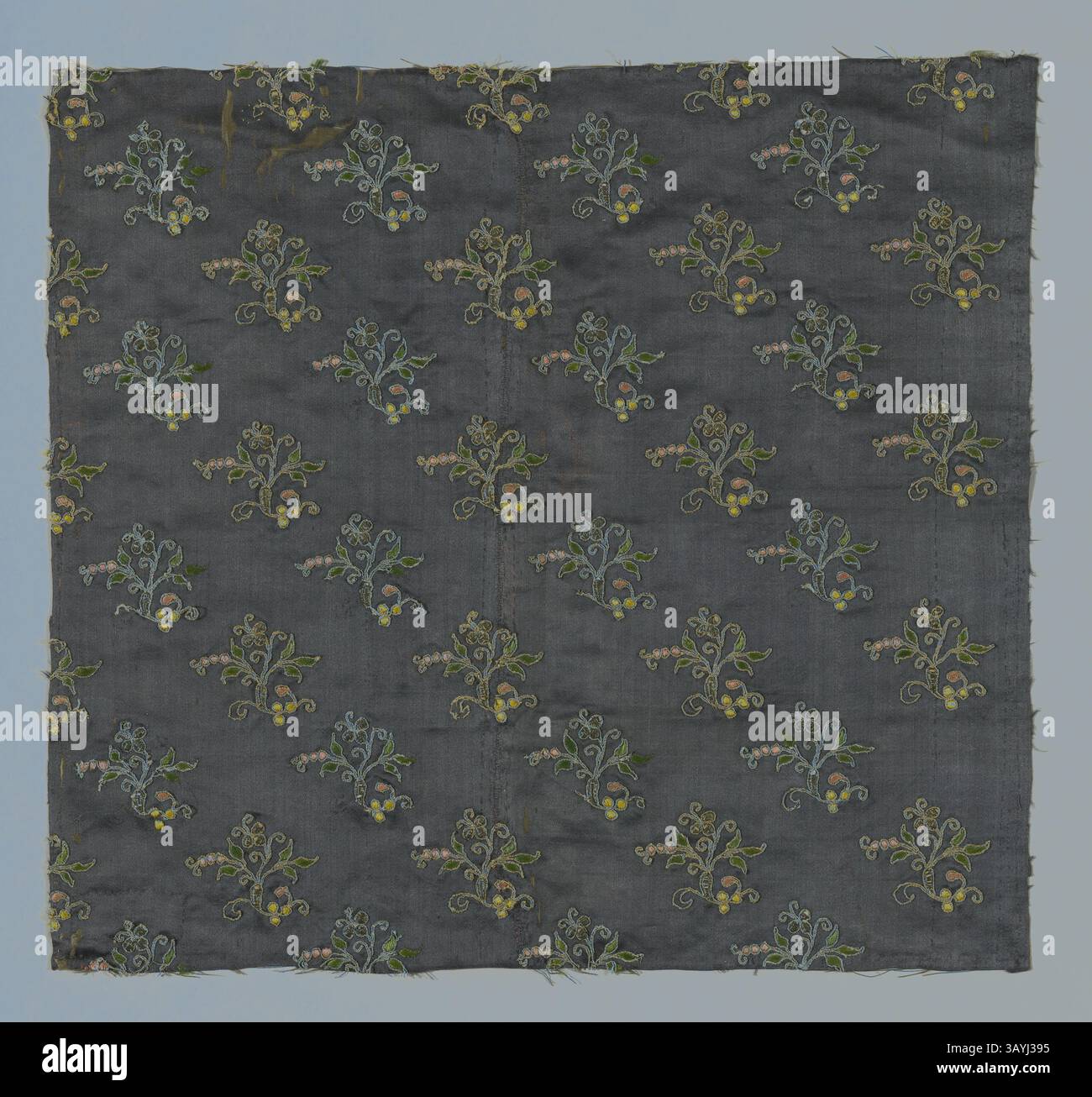 A richly textured fabric featuring intricate floral patterns, with ...