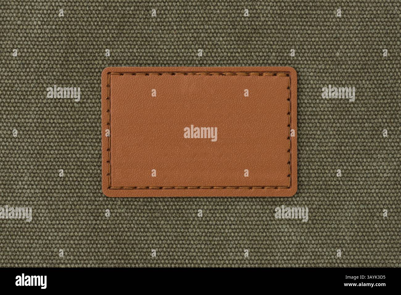 Leather label on olive green military cotton Stock Photo - Alamy