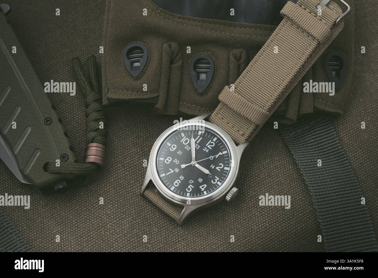 Close up black dial military style wristwatch with biege nylon watch ...