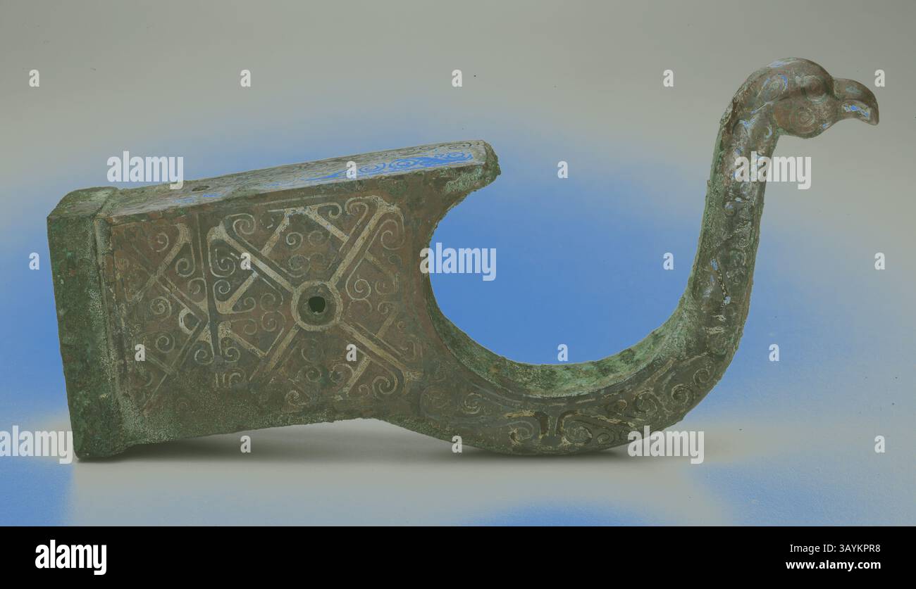 An intricately designed artifact featuring a stylized bird head, with ...