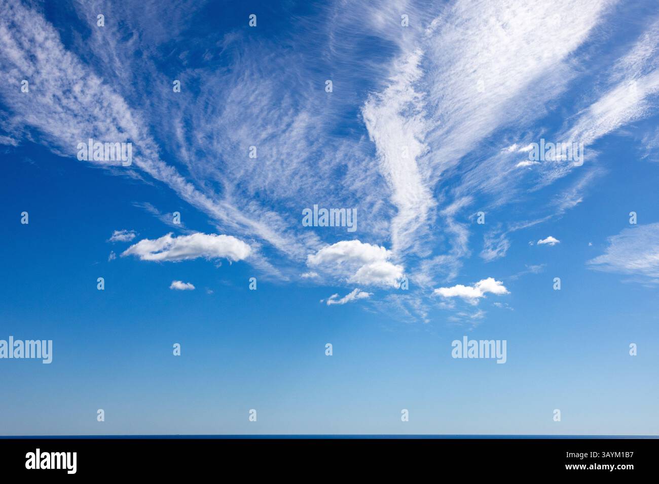 Big Blue Sky with white clouds streak across the sky Stock Photo - Alamy