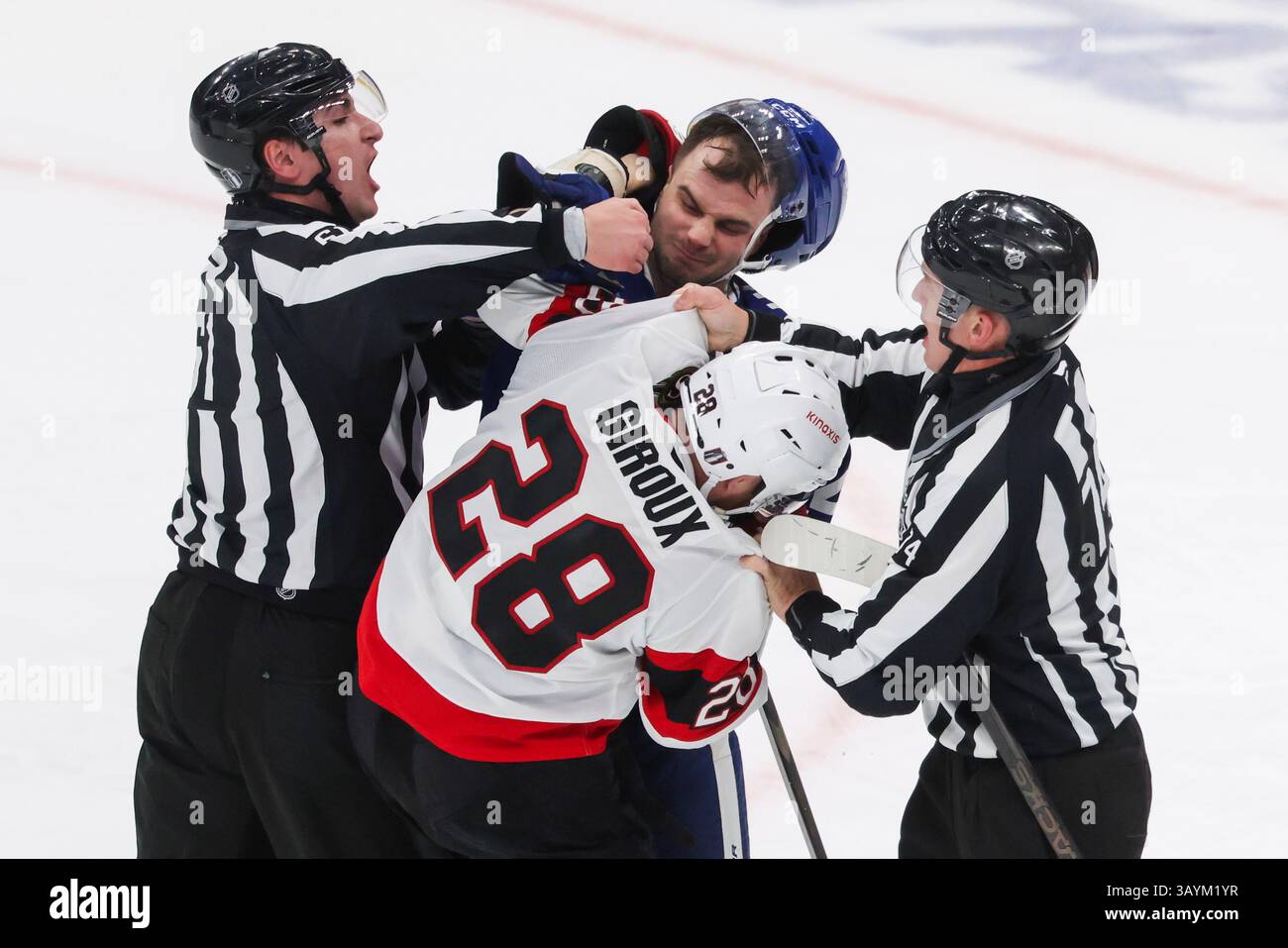 Referees break up a fight between Toronto Maple Leafs' Scott Laughton ...