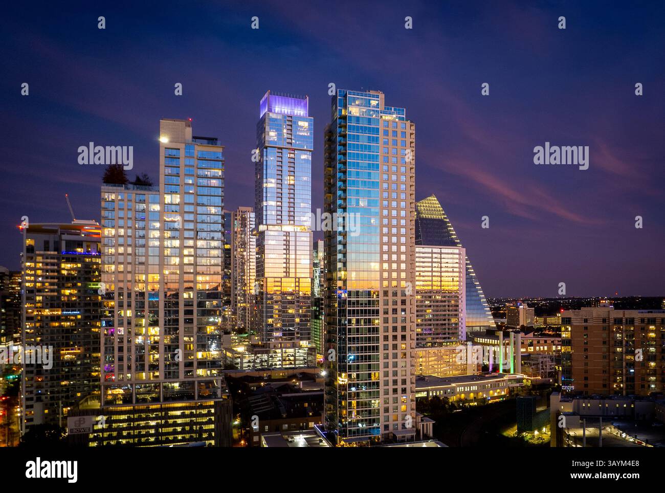 Sunset colours reflected from the faces of several high-rise buildings ...
