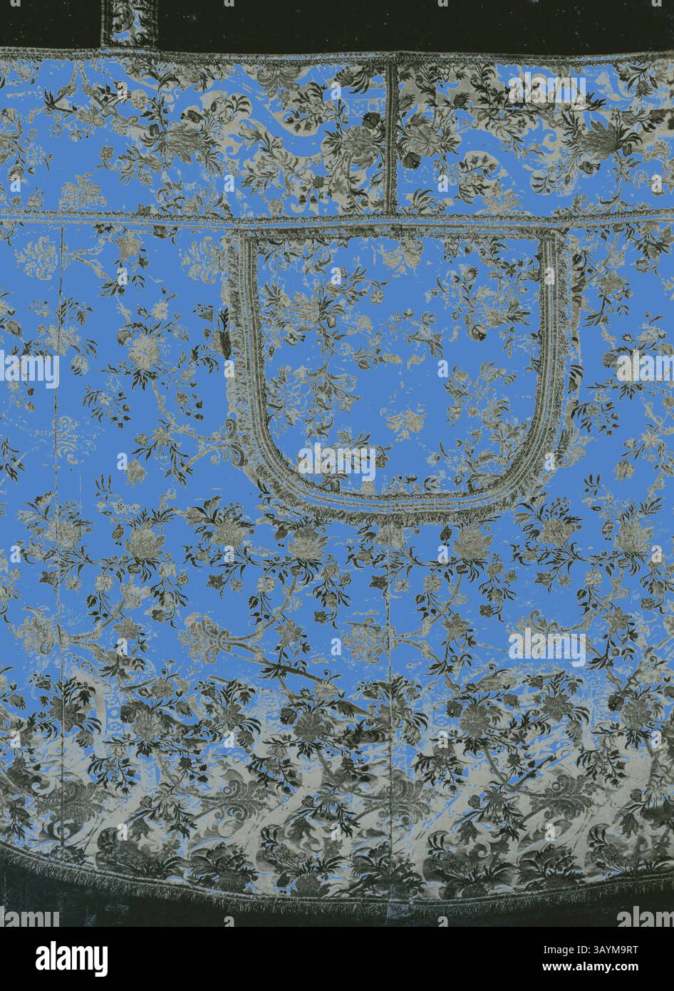 An intricately patterned textile features a vibrant blue background ...