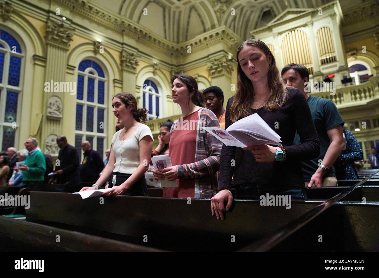 Students from Loyola University Maryland partake in a prayer service in ...