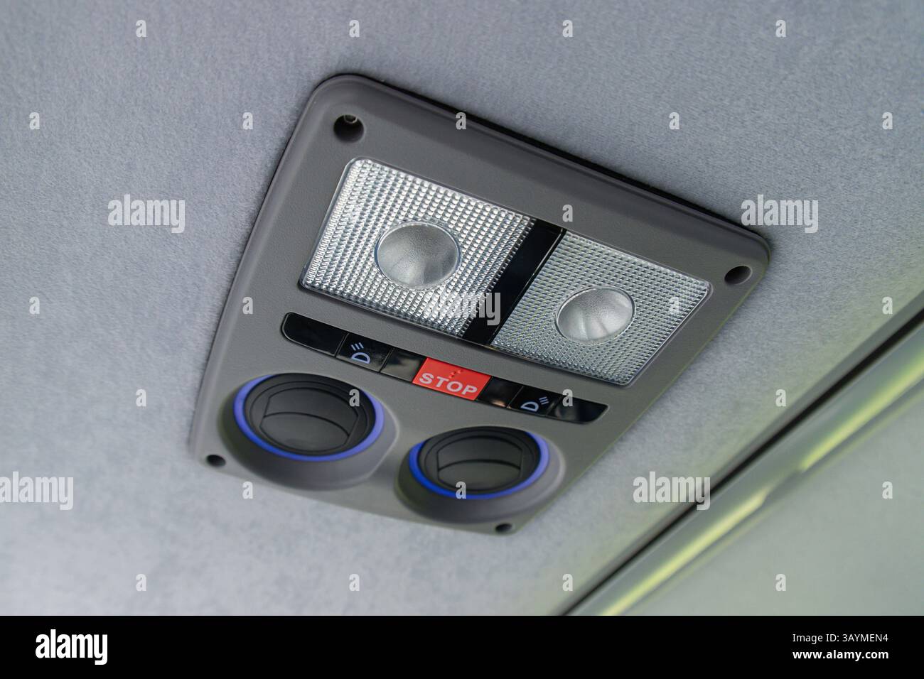 Close-up of an overhead passenger control unit in a bus, featuring air ...