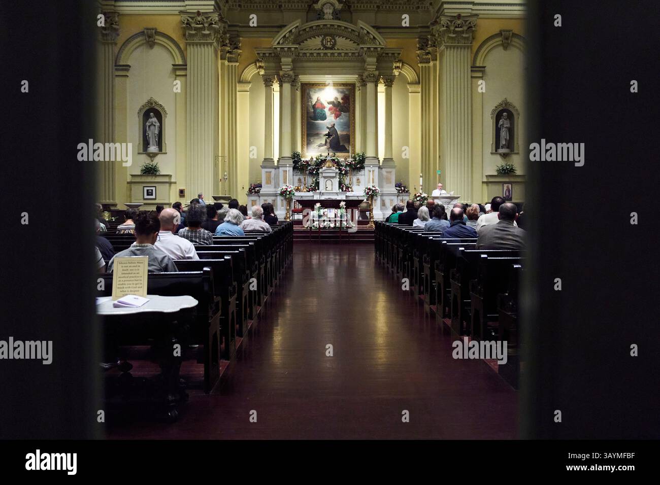 As seen through a window, Rev. Brian Frain, of the Society of Jesus ...