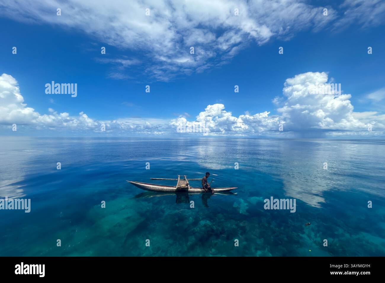 Indigenous male of the Vitu Islands in a traditional dugout canoe ...