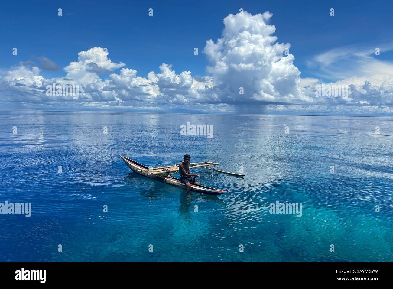 Indigenous male of the Vitu Islands in a traditional dugout canoe ...