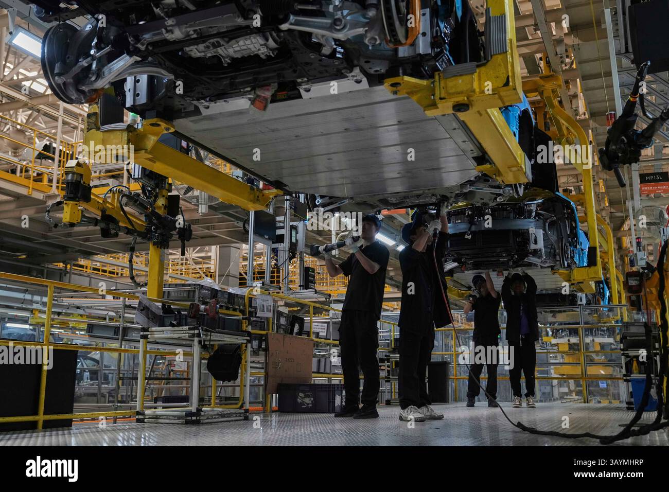 Workers assemble the Zeekr 001 EV models at the Chinese automaker Zeekr ...