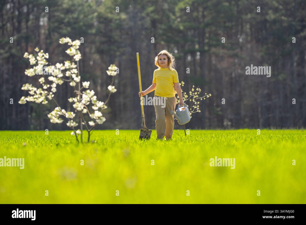 Child working in the garden yard. Growth tree and care plant for the ...