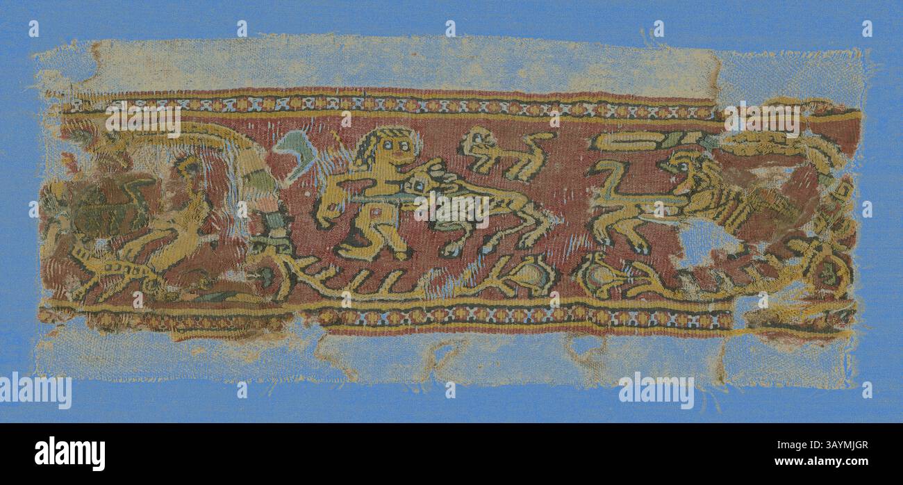 An ancient textile featuring intricate designs of mythical creatures ...