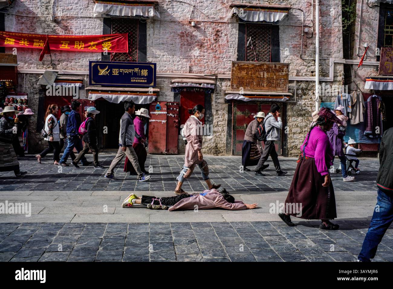 In the heart of Lhasa’s old town, Tibetan pilgrims are seen performing ...