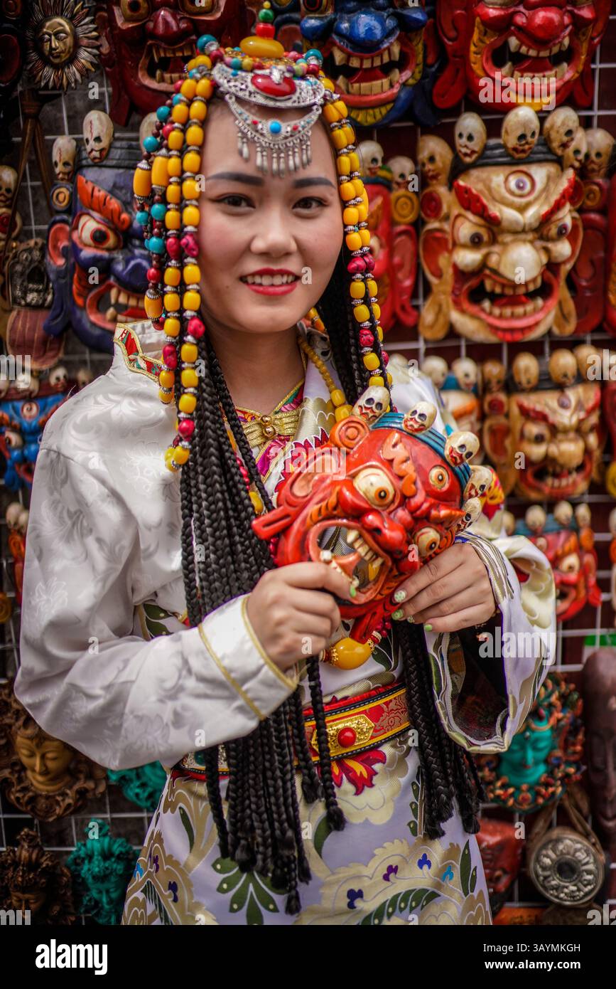 A compelling portrait of a Tibetan woman in traditional dress, her face ...