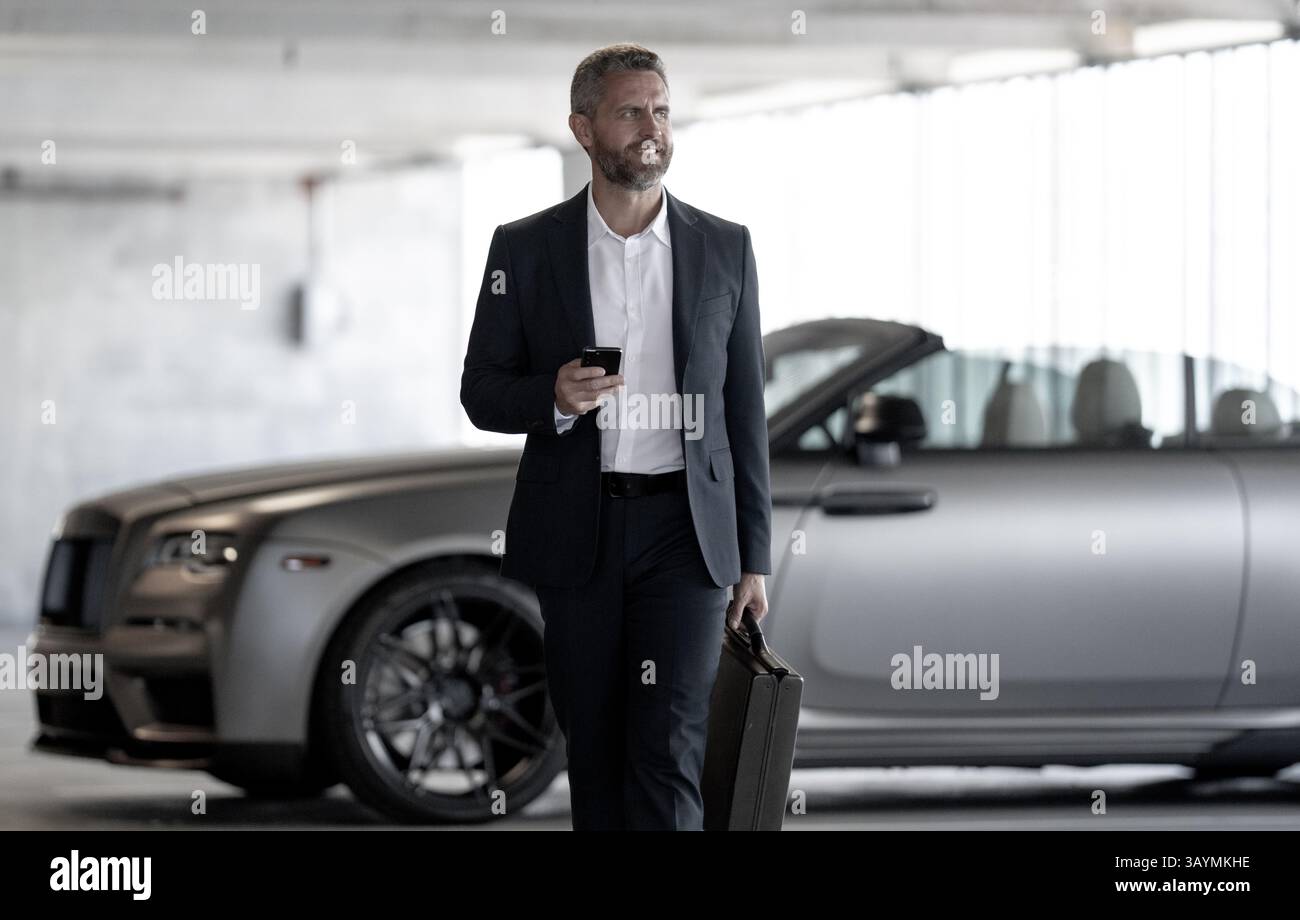 Successful business man in suit outdoors. Rich businessman next to a ...