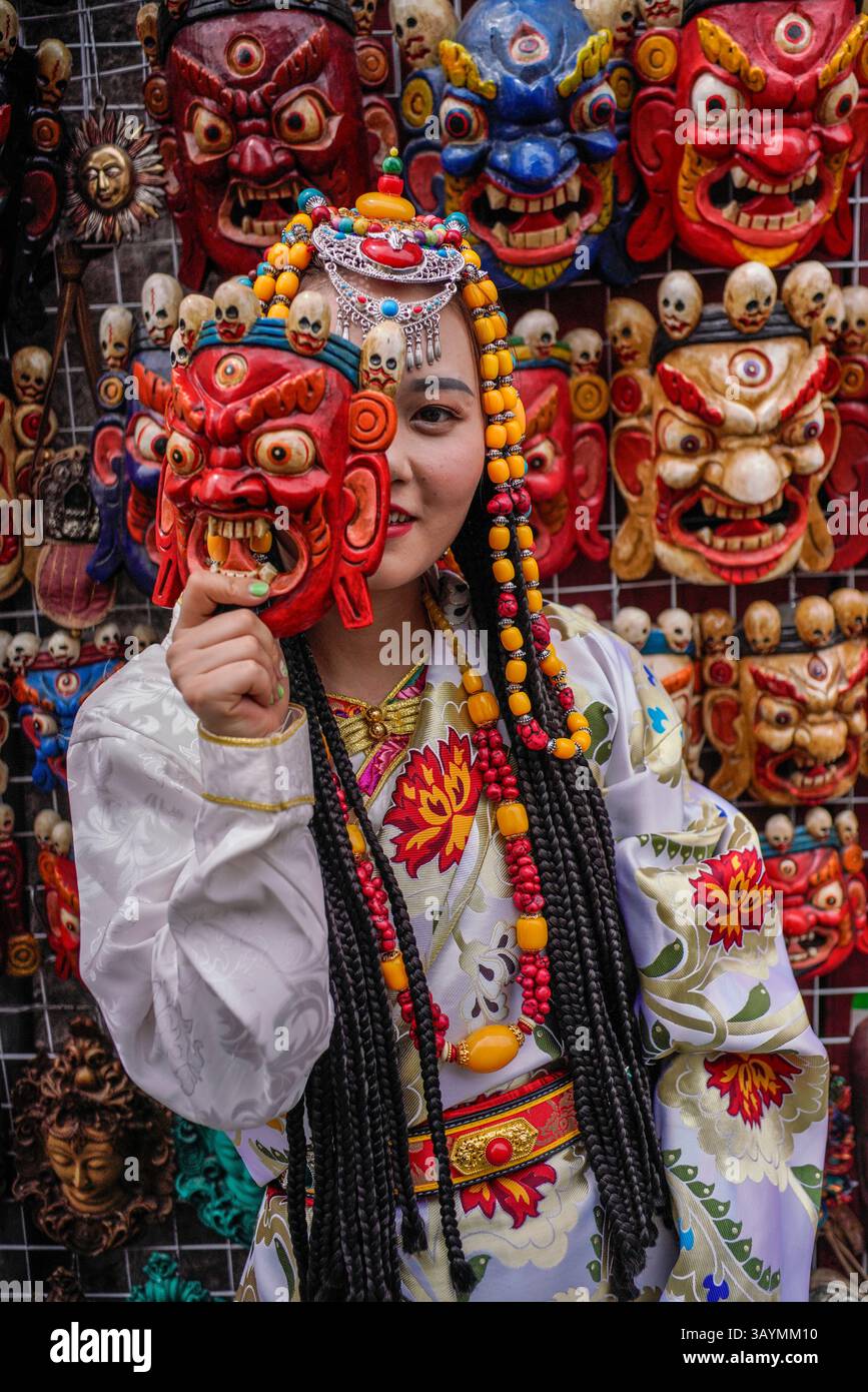 A compelling portrait of a Tibetan woman in traditional dress, her face ...