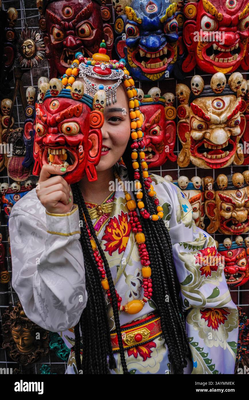 A compelling portrait of a Tibetan woman in traditional dress, her face ...