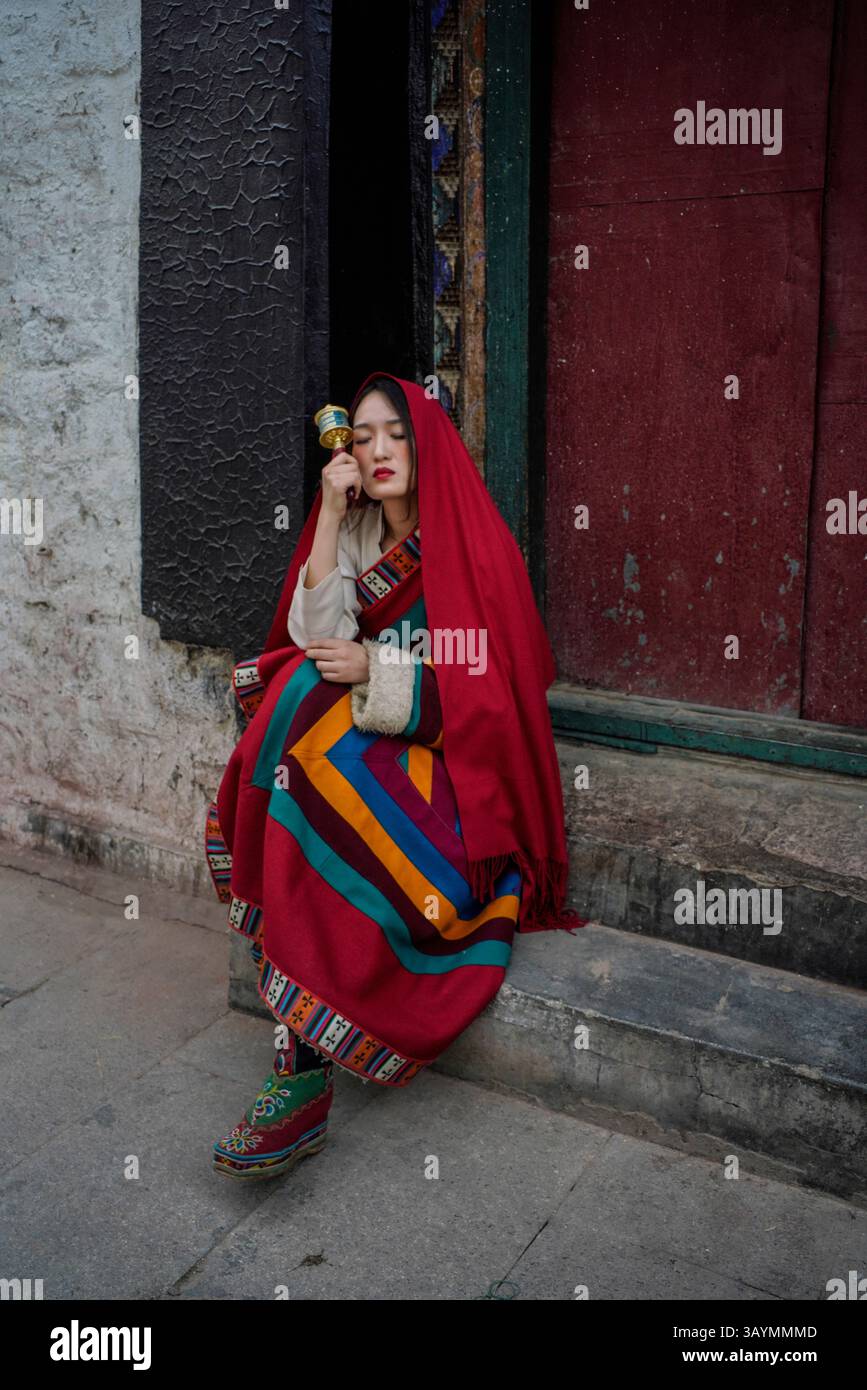 Young Chinese tourists dressed in stylized traditional clothing pose ...