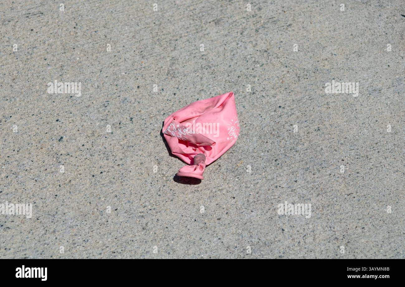 pink balloon plastic deflated remnants Stock Photo - Alamy