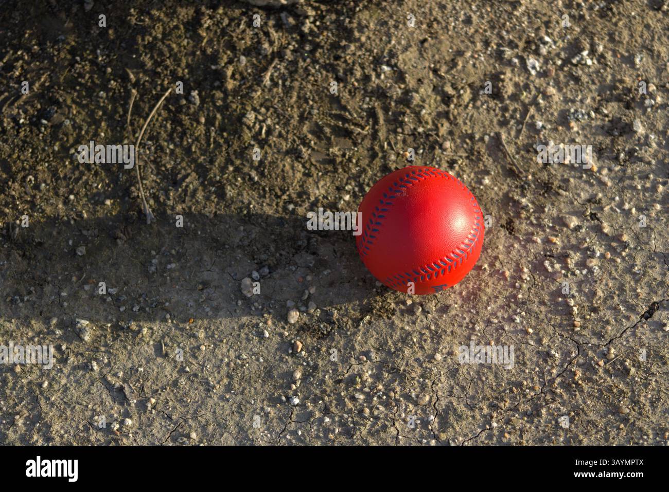 red baseball with navy stitching Stock Photo - Alamy