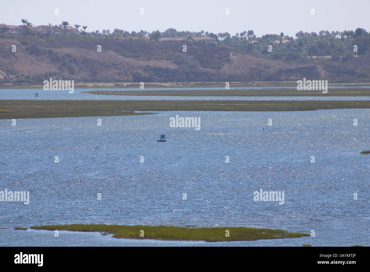 coastal landscape with blue water and greenery Stock Photo - Alamy