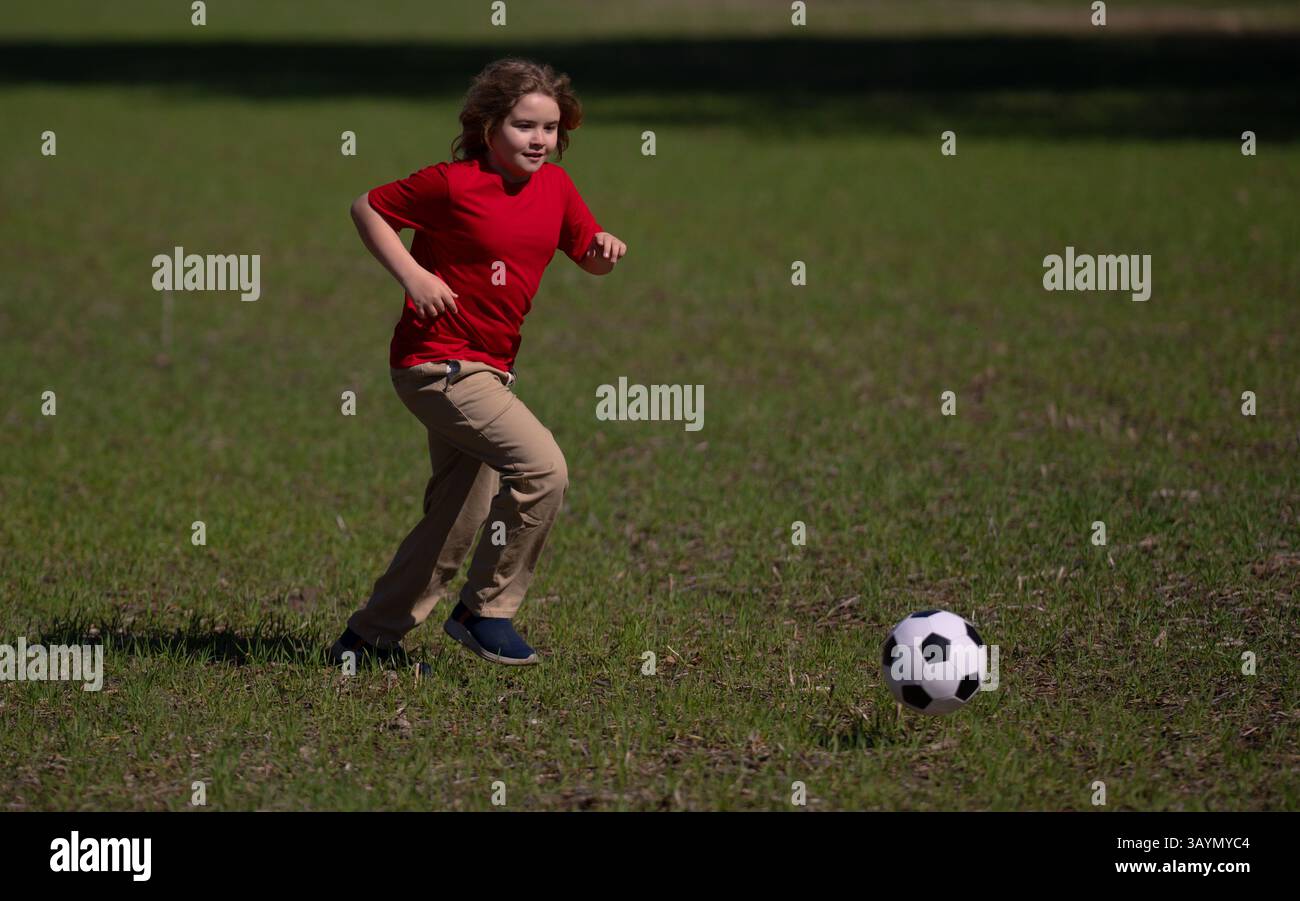 Sport child is playing football. A child kicks the soccer ball. Kids ...