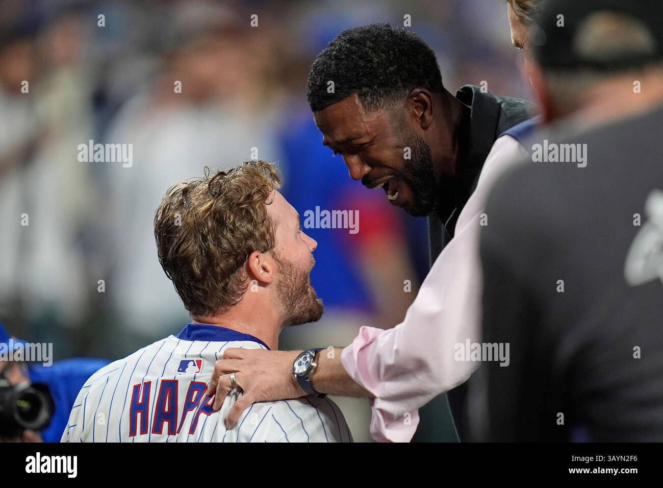 Chicago Cubs' Ian Happ (8), left, is greeted by former teammate Dexter ...