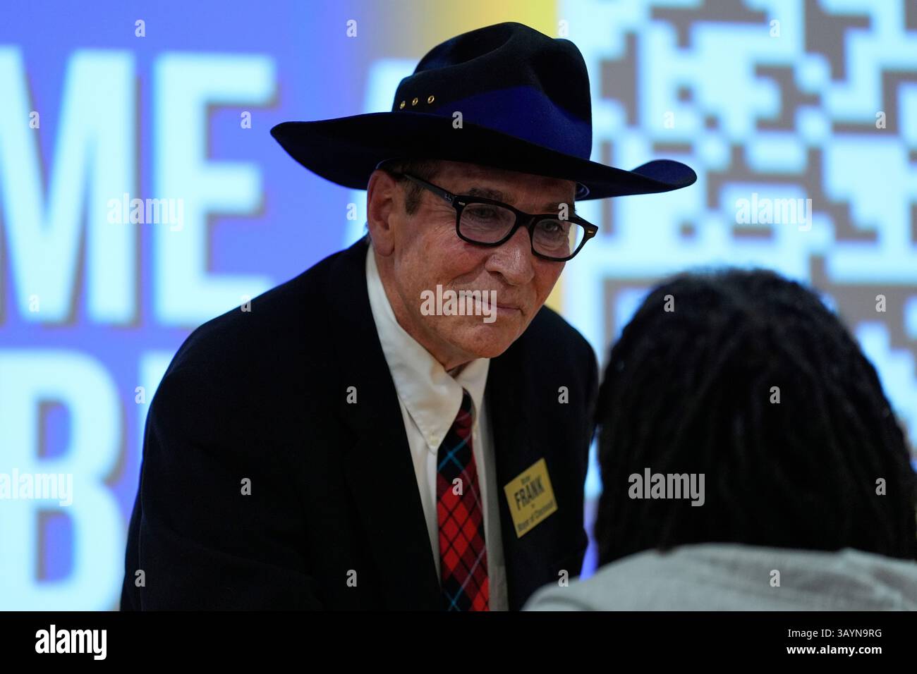 Cincinnati mayoral candidate Brian Frank talks with a person in the ...