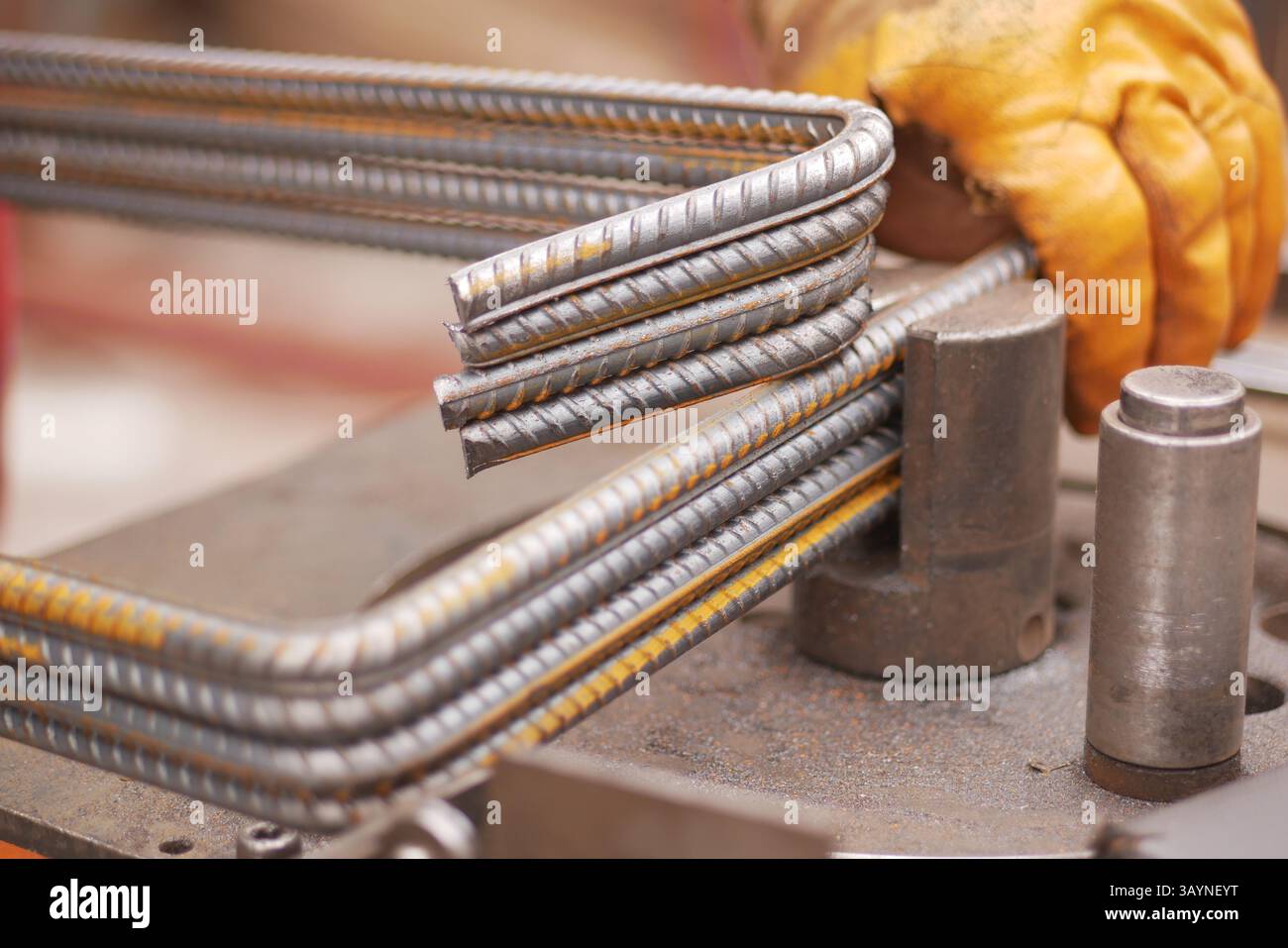 Metal bending process in construction site workshop during daytime ...