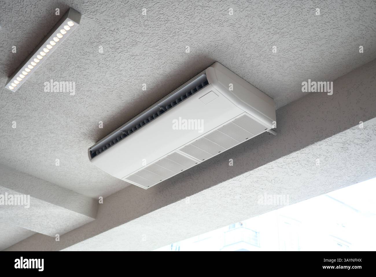 Ceiling-mounted air conditioning unit in a modern room interior Stock ...
