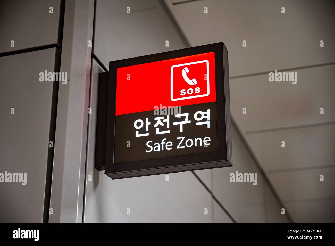 A safe zone sign with a white telephone icon and the letters "SOS" on a ...