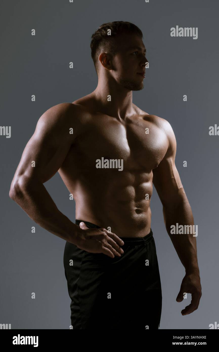 A fit male model showcases his strength in a captivating pose under ...