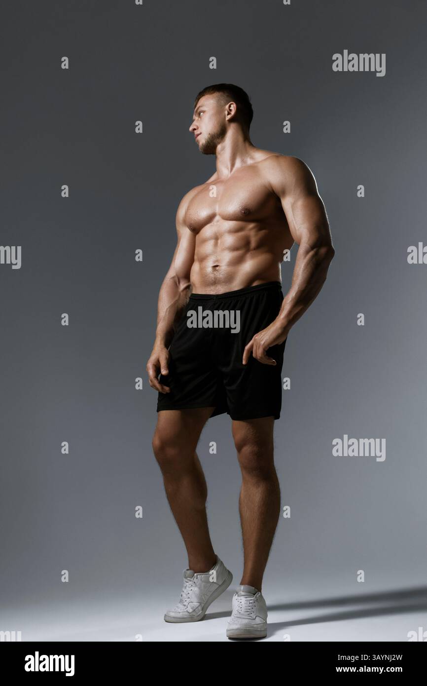 A fit male model showcases his strength in a captivating pose under ...