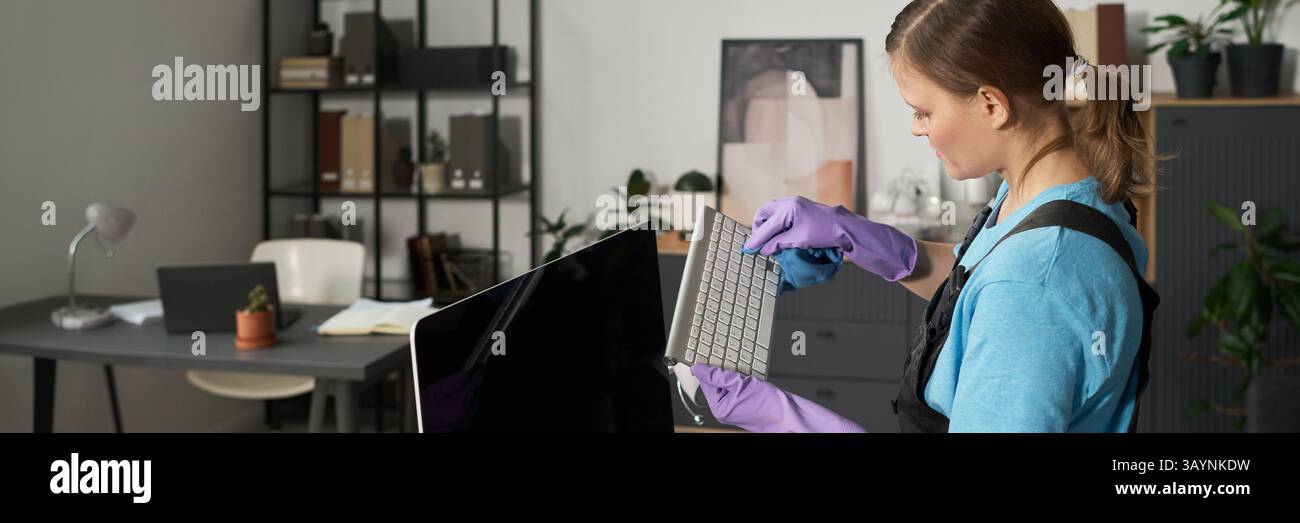 Cleaning Worker Wiping Computer In Office Stock Photo - Alamy