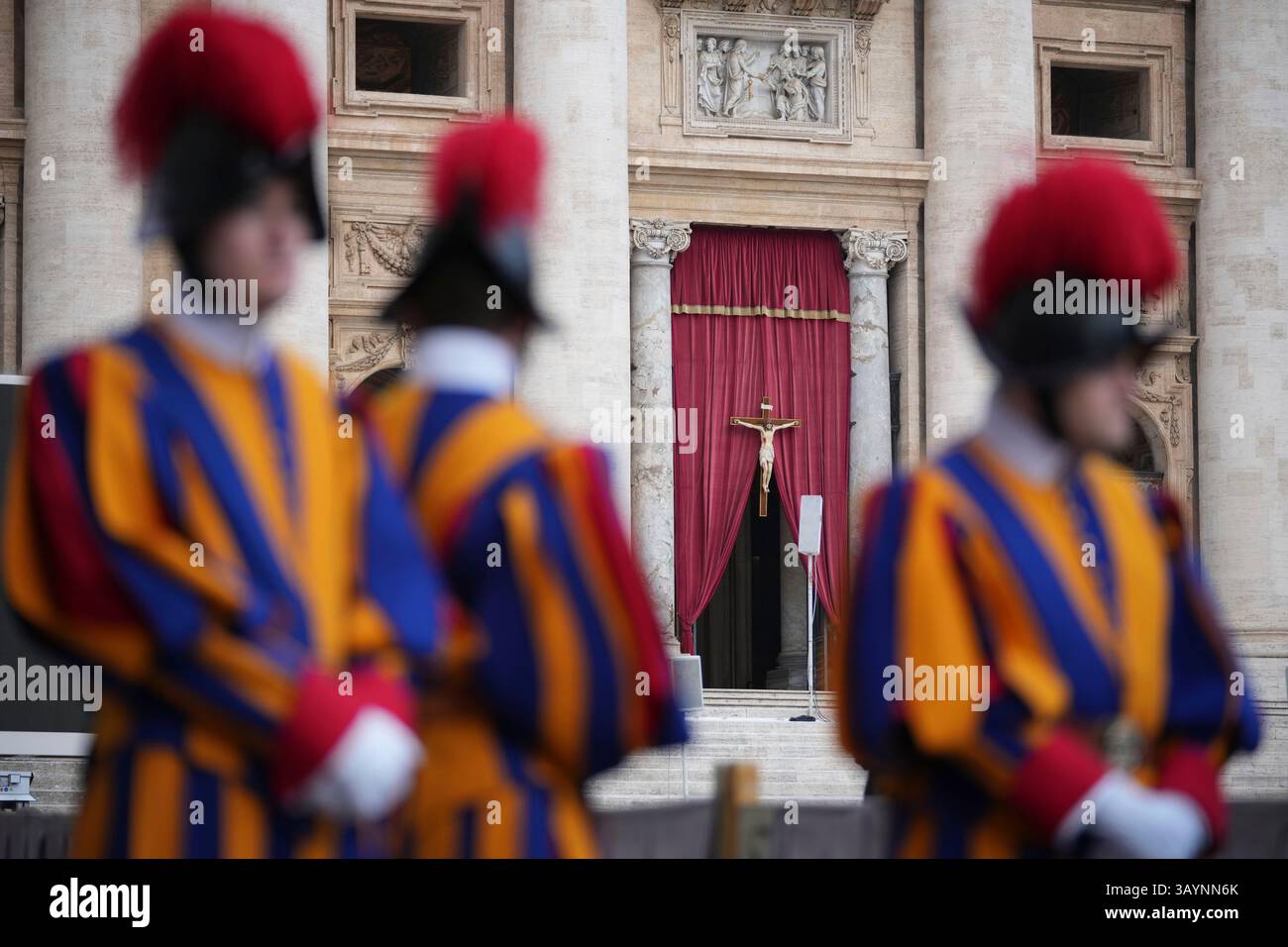 Vatican Swiss Guards frame the entrance of St. Peter's Basilica where ...