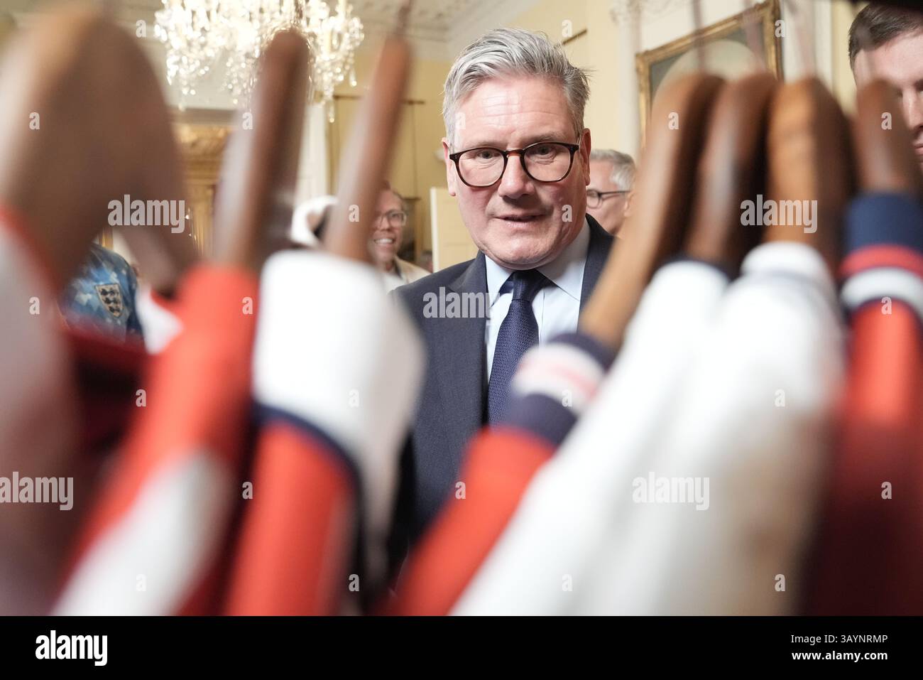 Prime Minister Sir Keir Starmer looking at football shirts during a ...