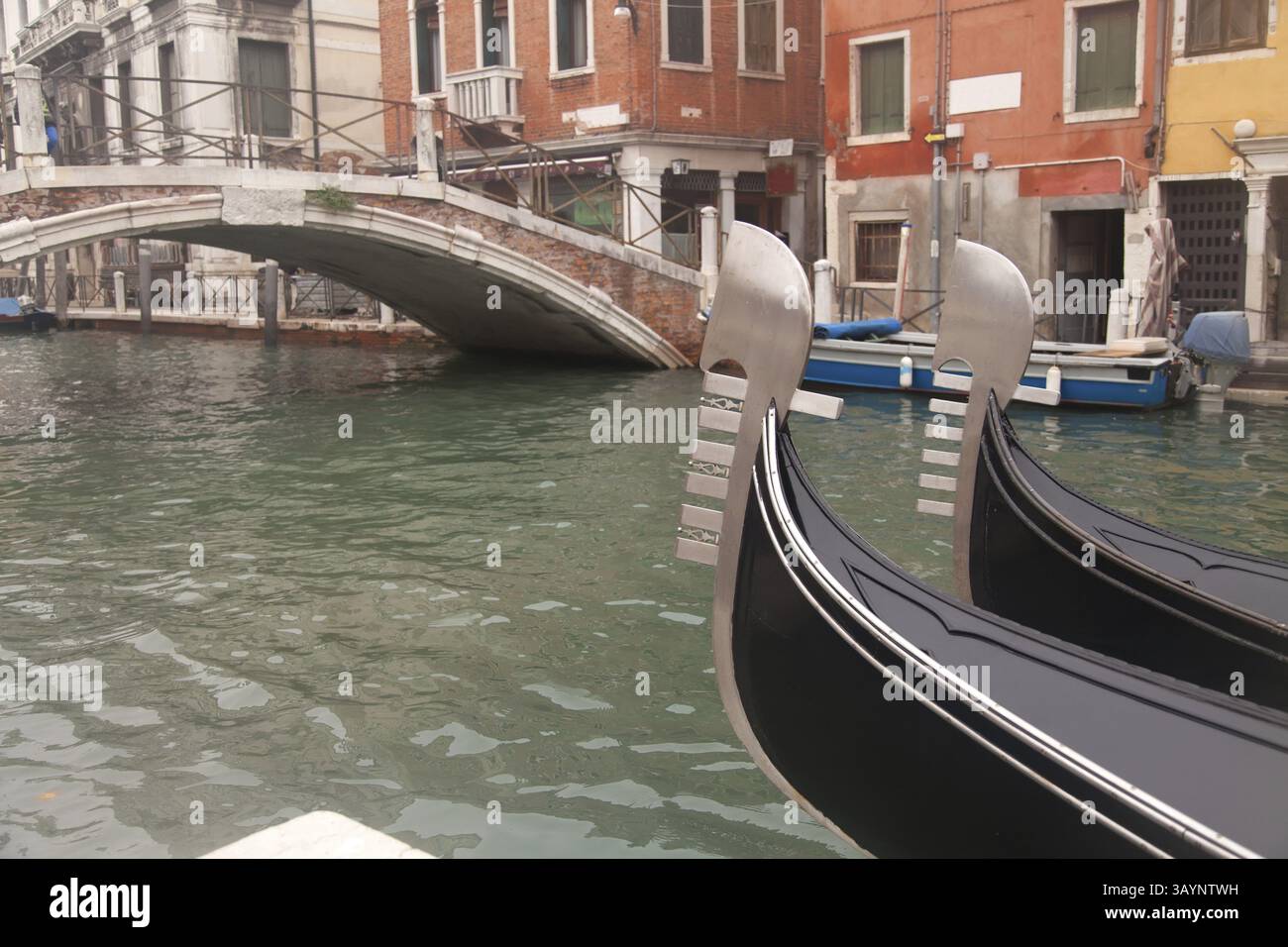 Two gondola in Venice near pier and bridge Stock Photo - Alamy