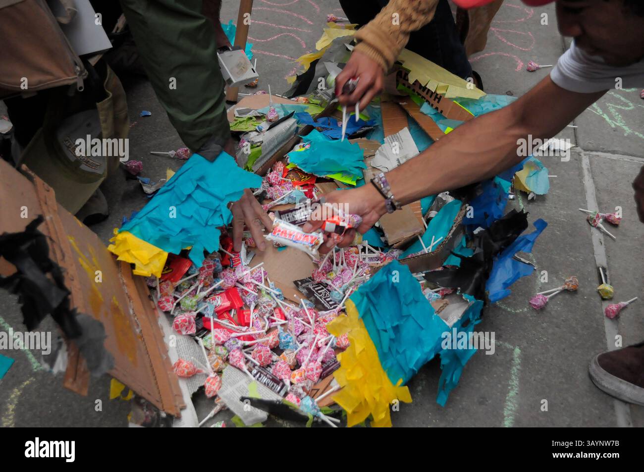 Climate activists take candy from a piñata of a Tesla Cybertruck that ...