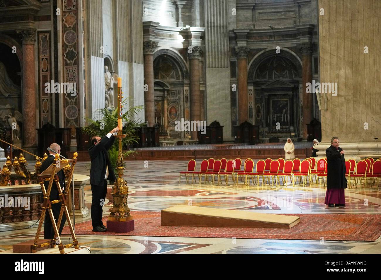 Workers make preparations in St. Peter's Basilica ahead of the arrival ...
