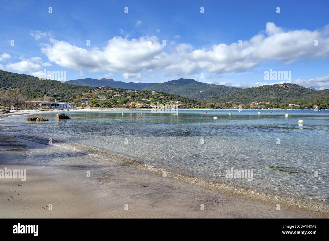 View of the gently sloping sandy beach of the Plage de Favona bathing ...