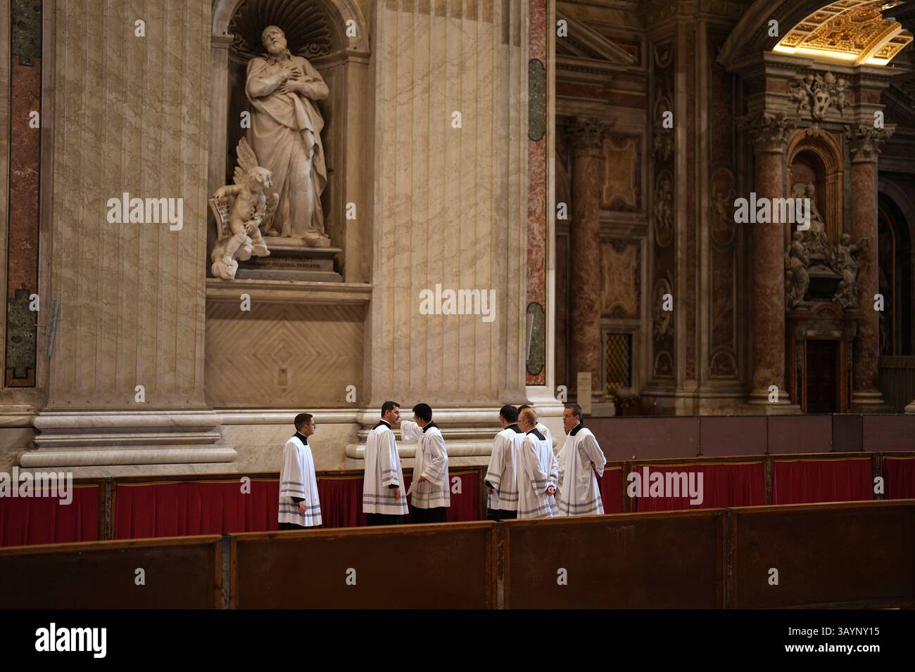 Staff inside St. Peter's Basilica at the Vatican finishes preparations ...
