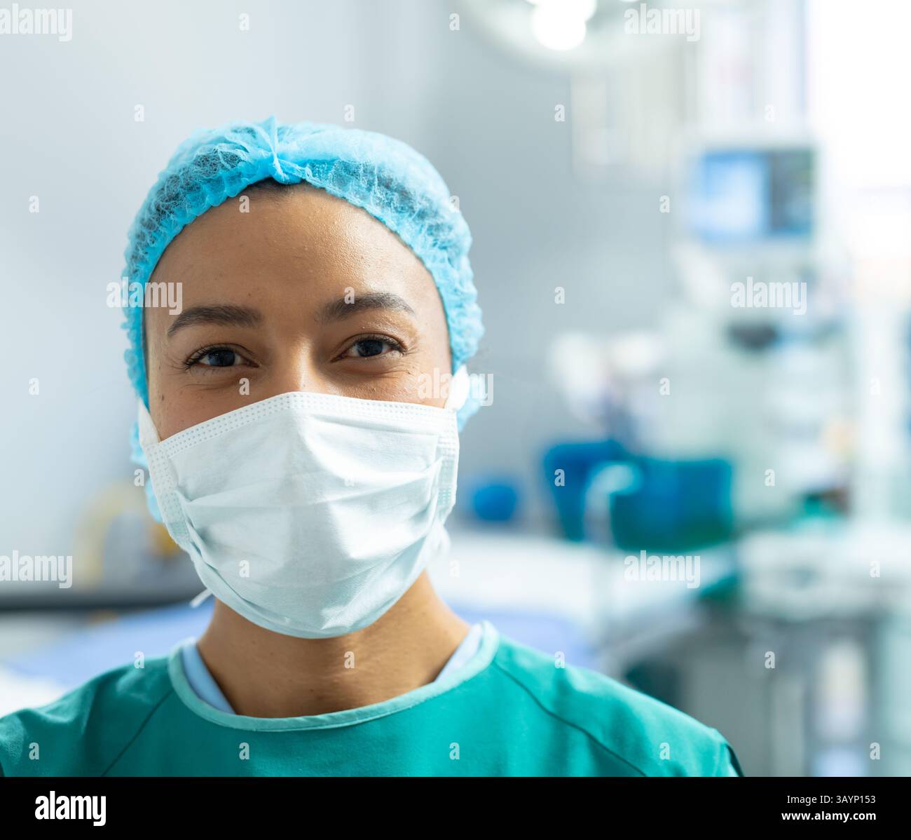 Mid adult African American woman standing in operating room, wearing ...