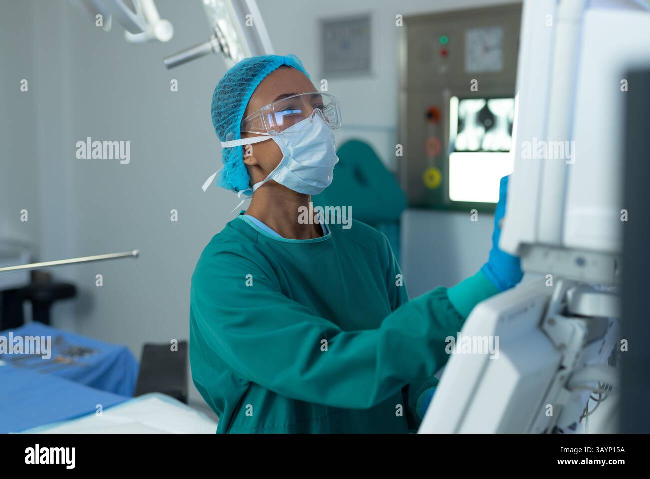 African American woman adjusting imaging monitor in operating room ...