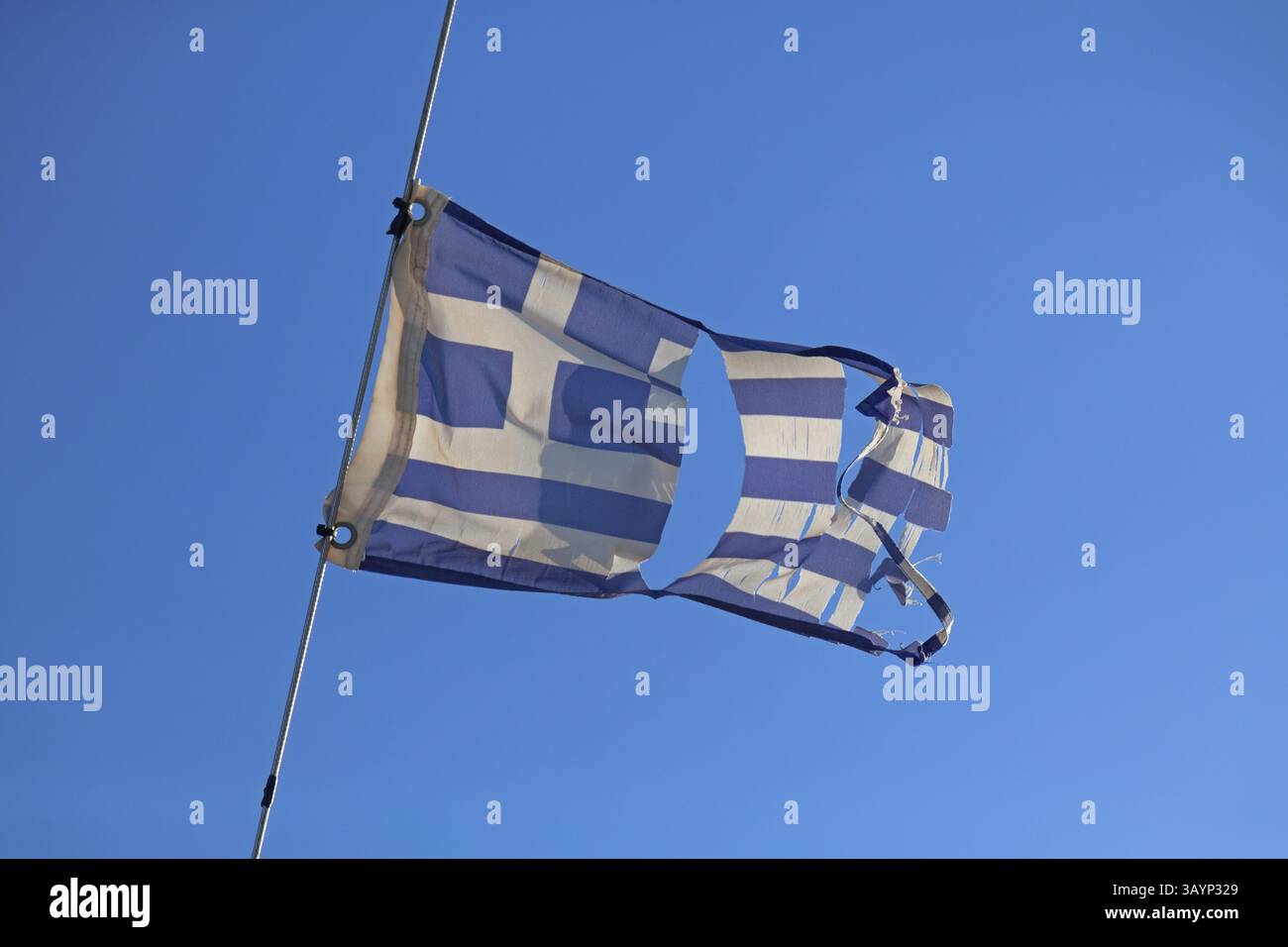 Torn greece flag waving on the wind Stock Photo - Alamy