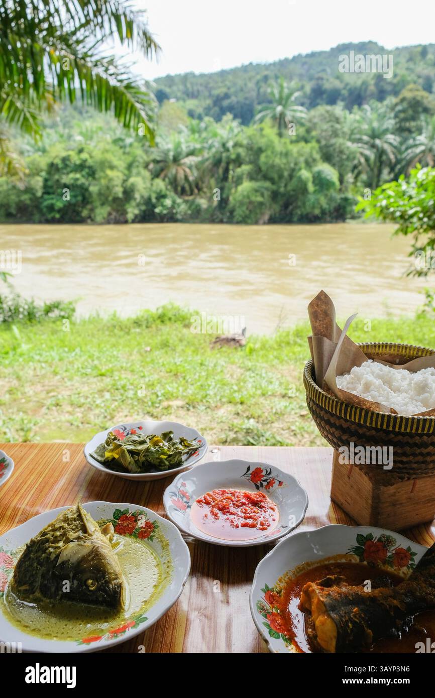 Eating traditional food from Riau near Kampar River Stock Photo - Alamy