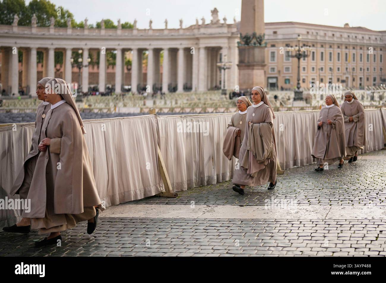 Nuns arrive in St. Peter's Square as they await the arrival of the body ...