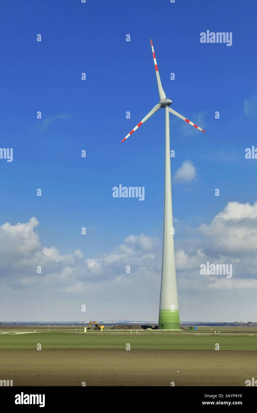 Rotating windmill blades in cloudy blue sky Stock Photo - Alamy